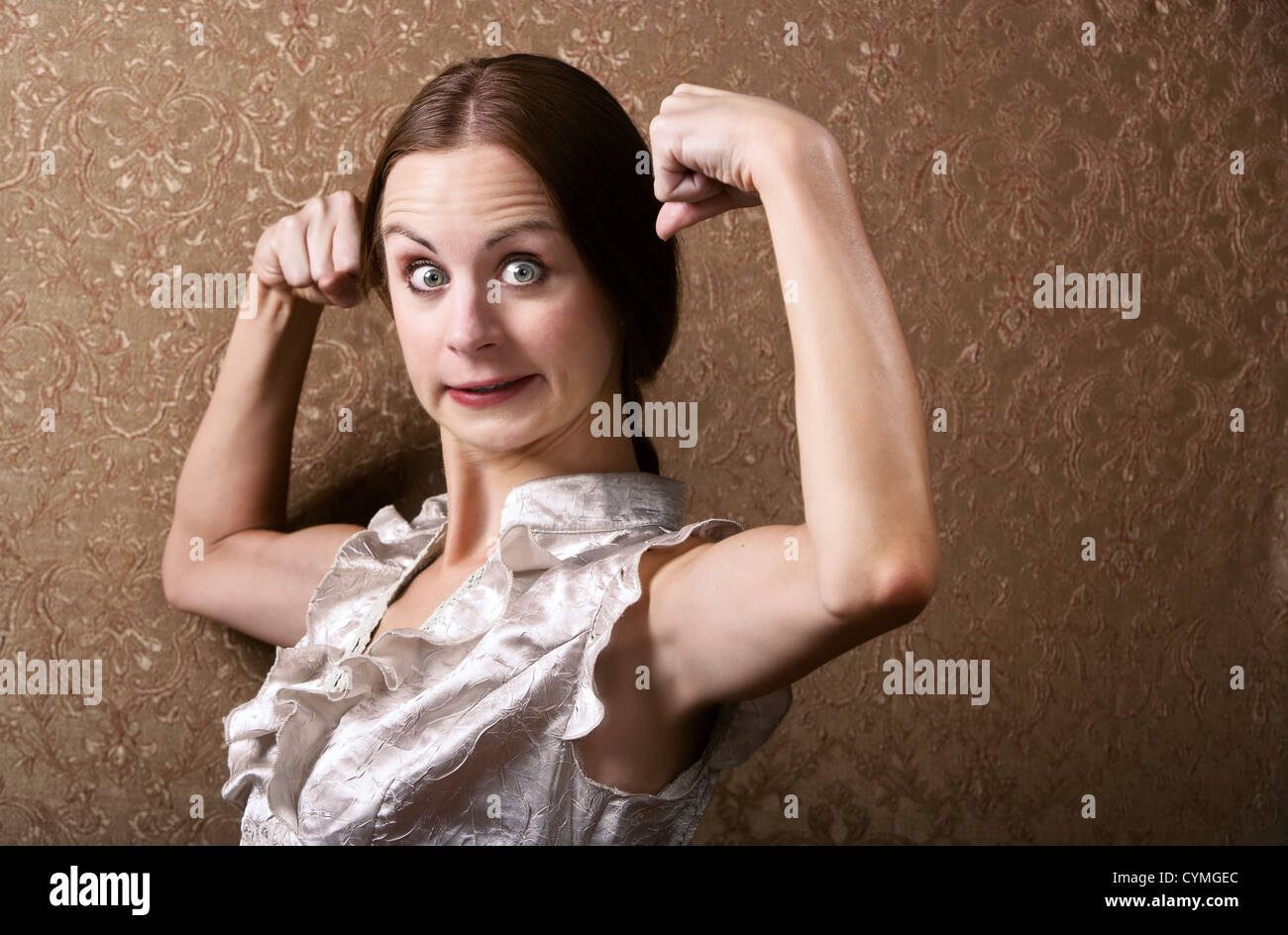 Pretty Young Woman Posing with Flexed Biceps Stock Photo - Alamy