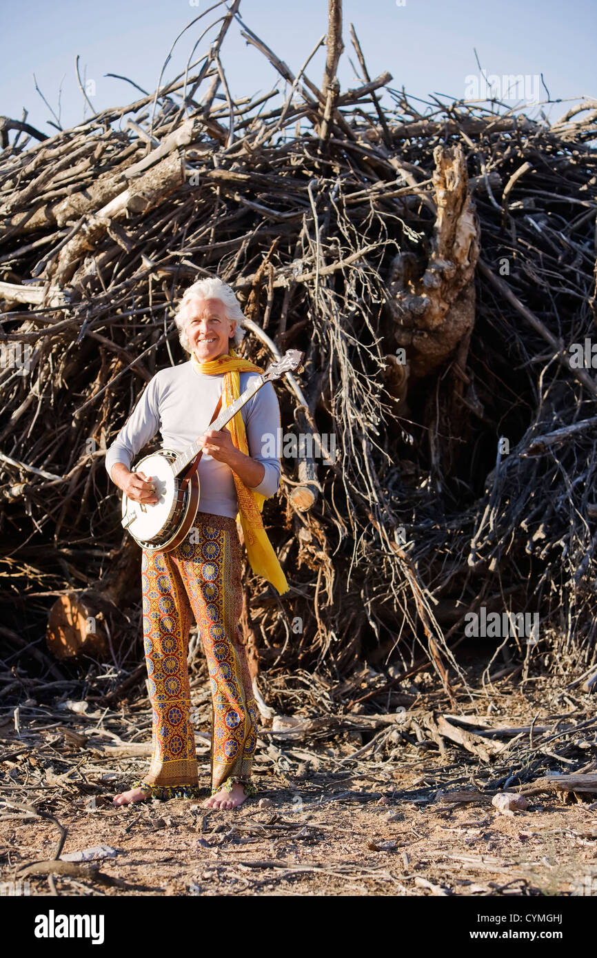 Barefoot banjo Player in Front of a Big Pile of Wood Stock Photo - Alamy