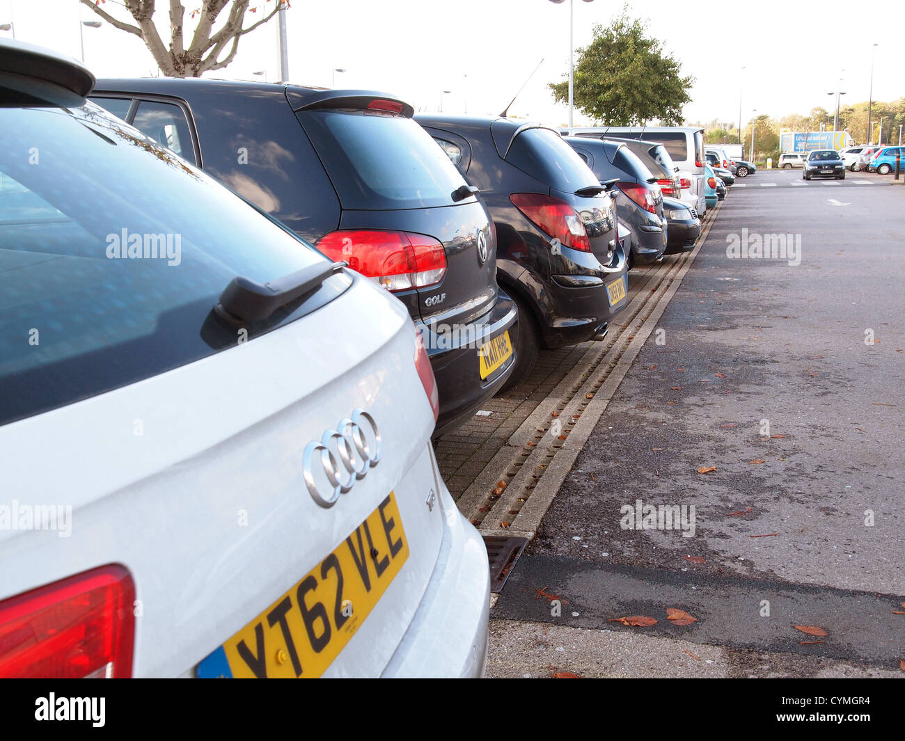 Line of parked cars in a retail park car park Stock Photo - Alamy