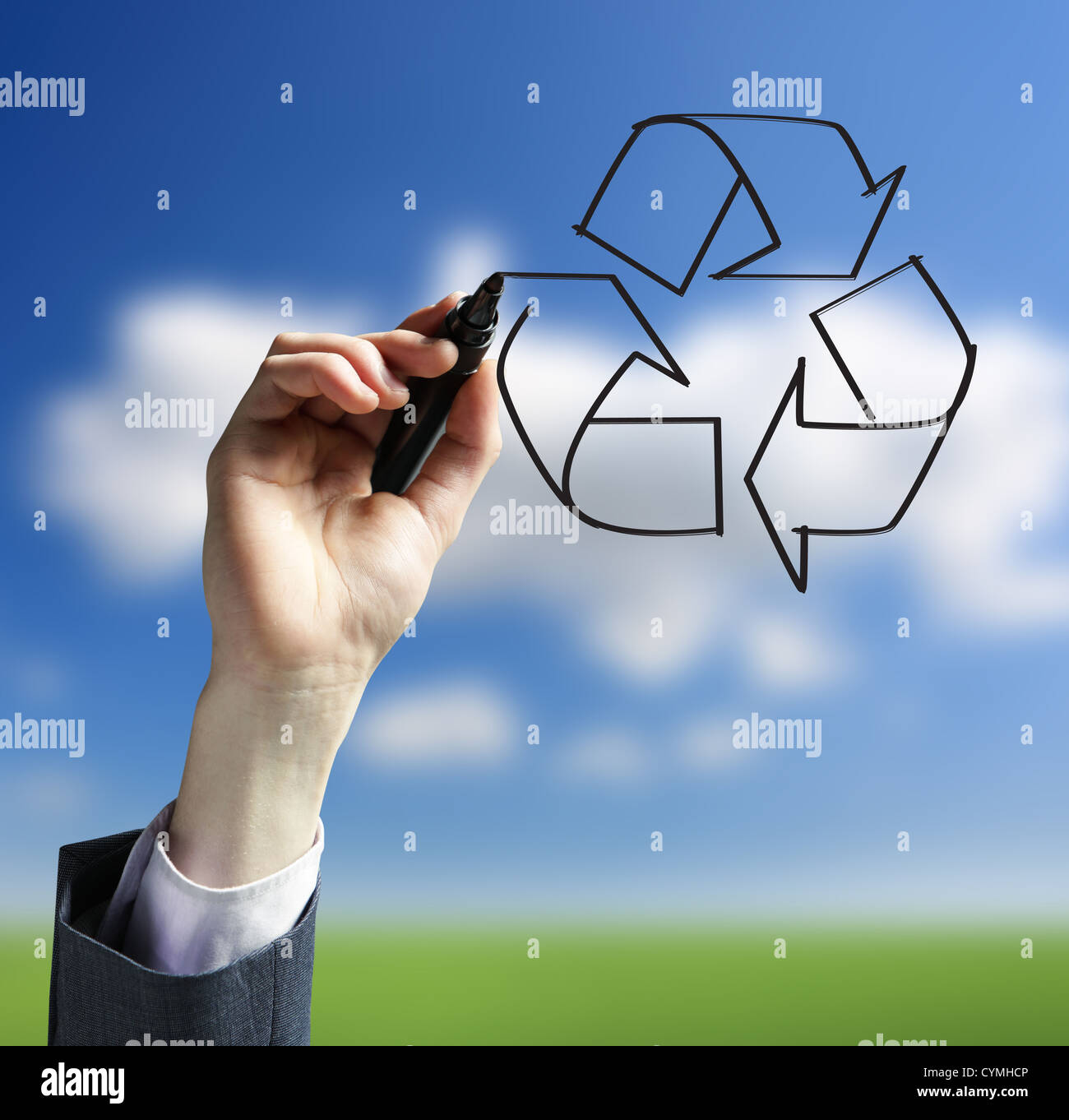 Businessman hand drawing a recycling logo Stock Photo - Alamy