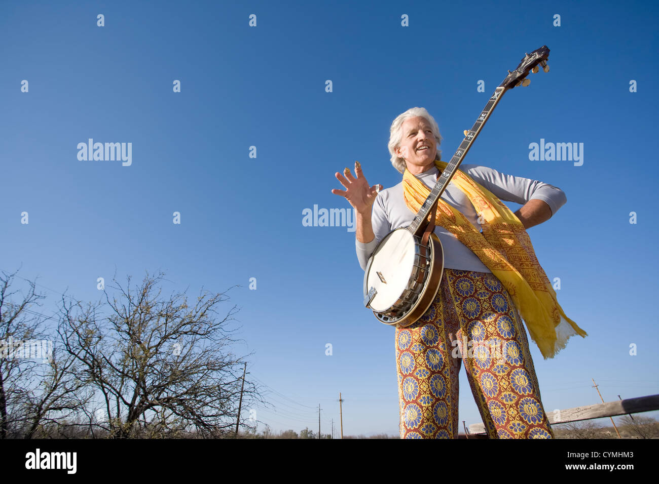 Banjo player standing against the blue sky Stock Photo - Alamy