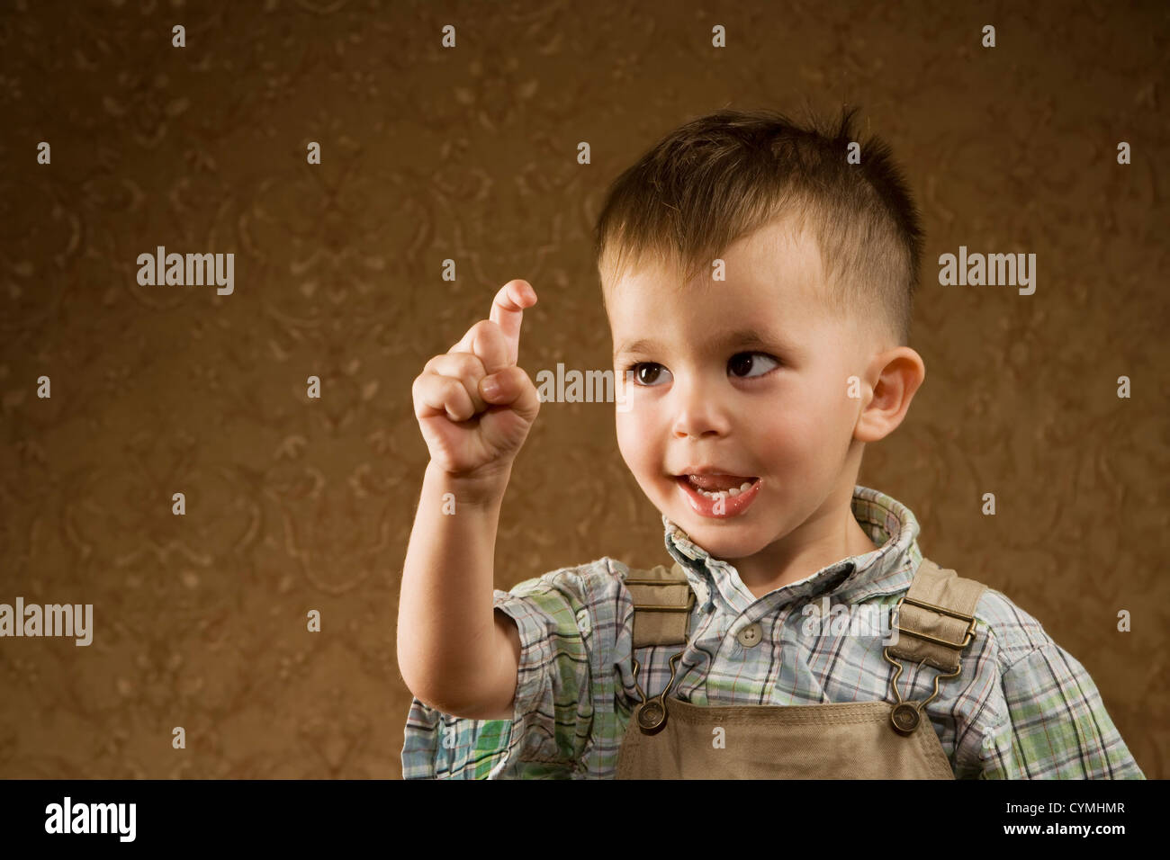 Portrait of a Happy Young Arabic boy Looking at his Finger Stock Photo ...