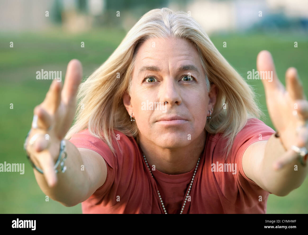 Handsome adult male with a friendly expression reaching towards the ...