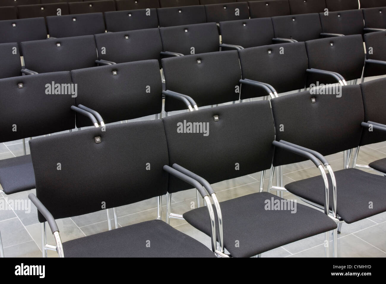 Black chairs of a lecture hall in a row Stock Photo - Alamy