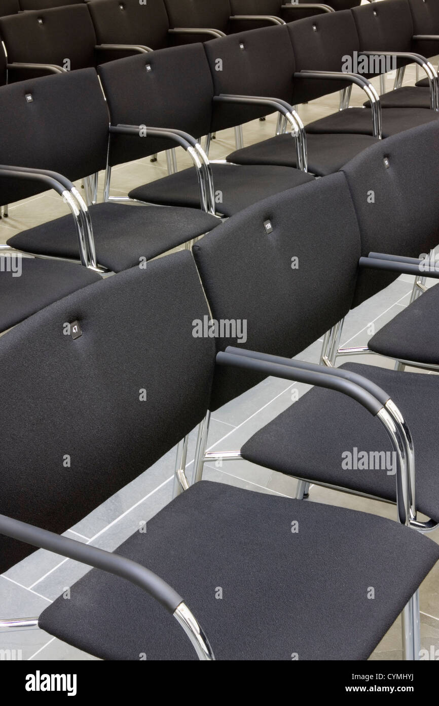 Black chairs of a lecture hall in a row Stock Photo - Alamy