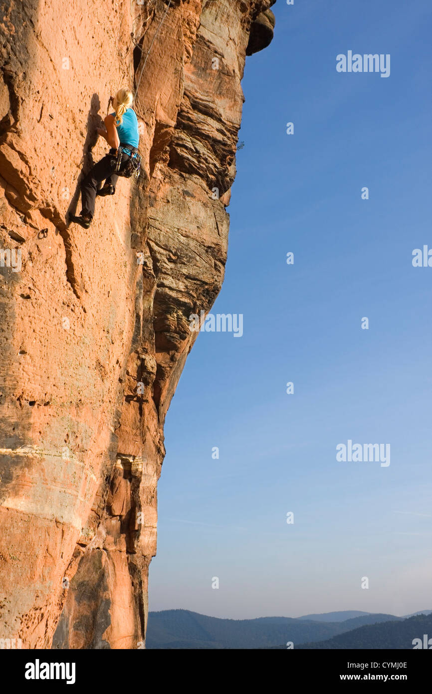 Young woman climbing a rock of sandstone Stock Photo - Alamy