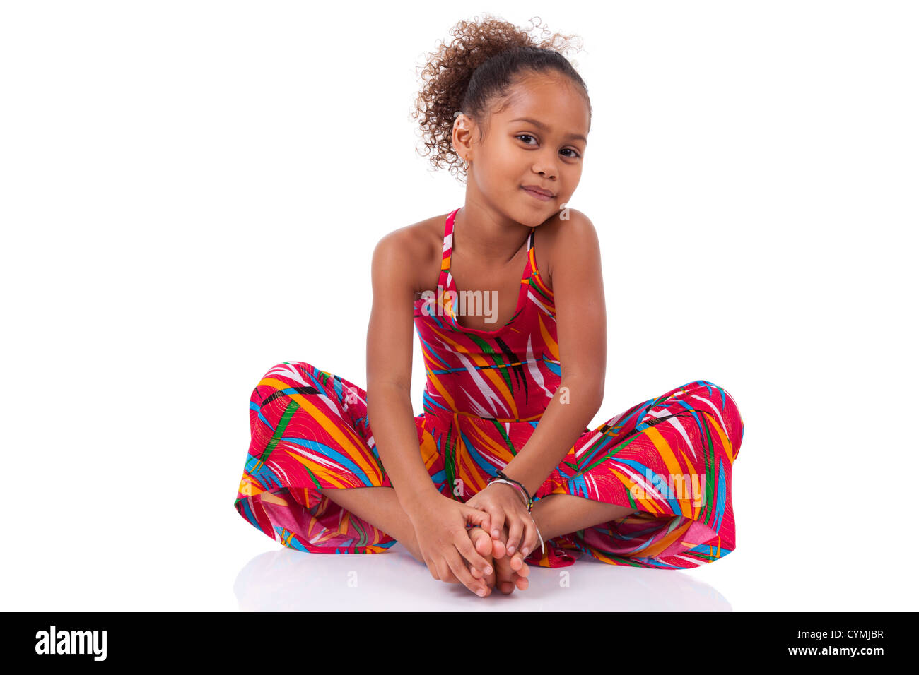 Portrait of a cute young African Asian girl seated on the floor Stock ...