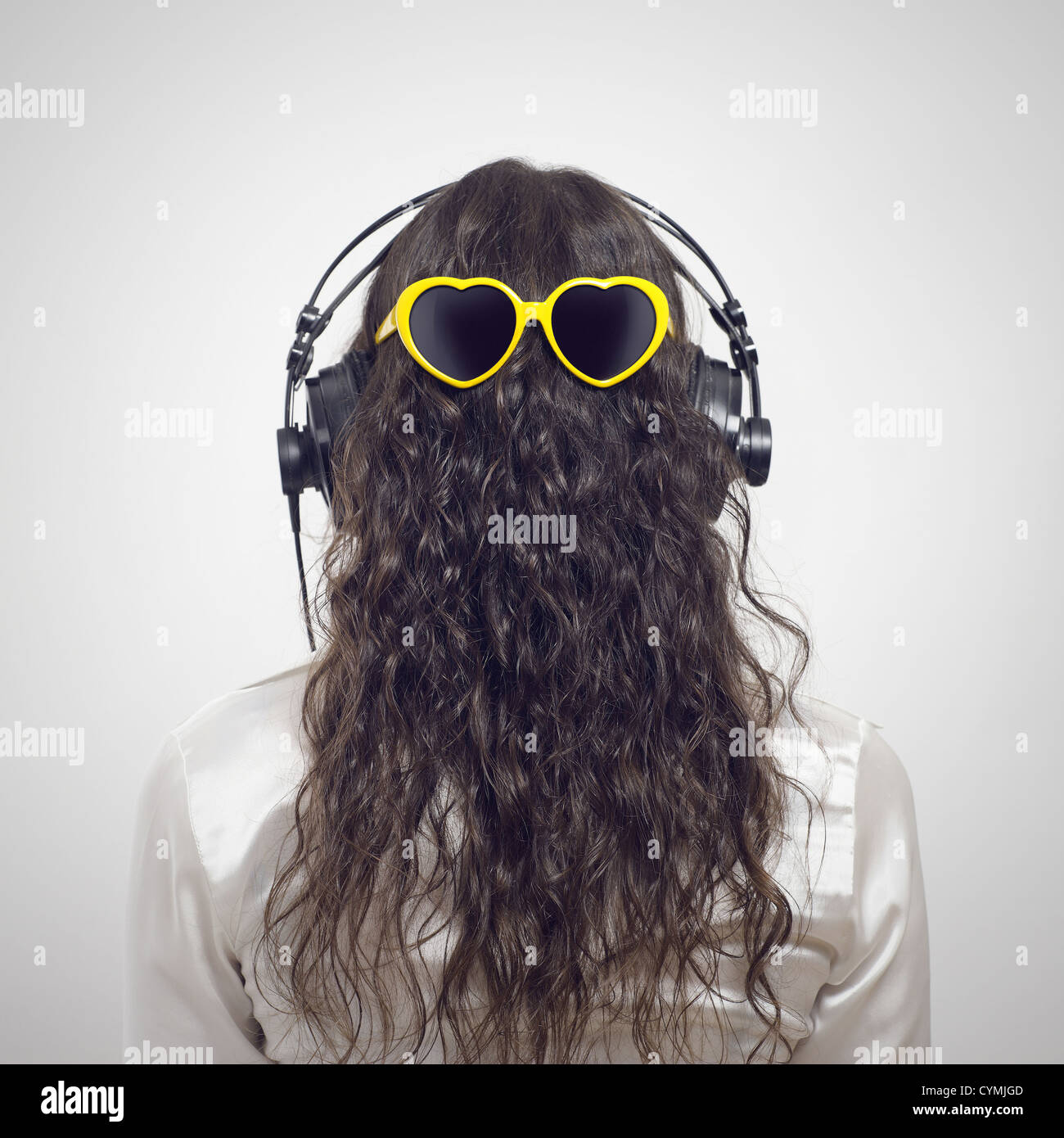 Young woman listening music, back view Stock Photo - Alamy