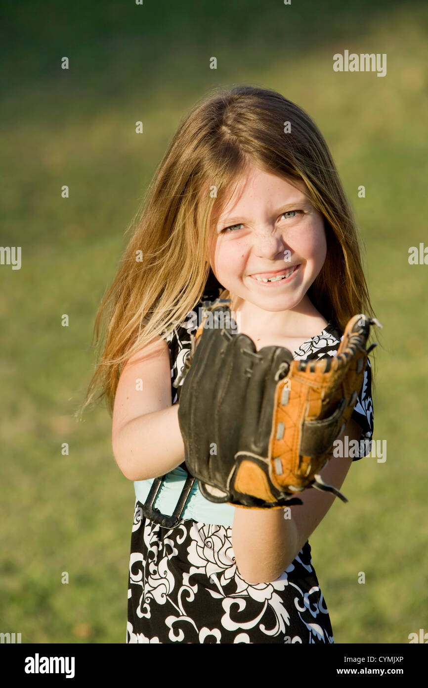 Cute young girl in summer dress with a baseball Stock Photo - Alamy