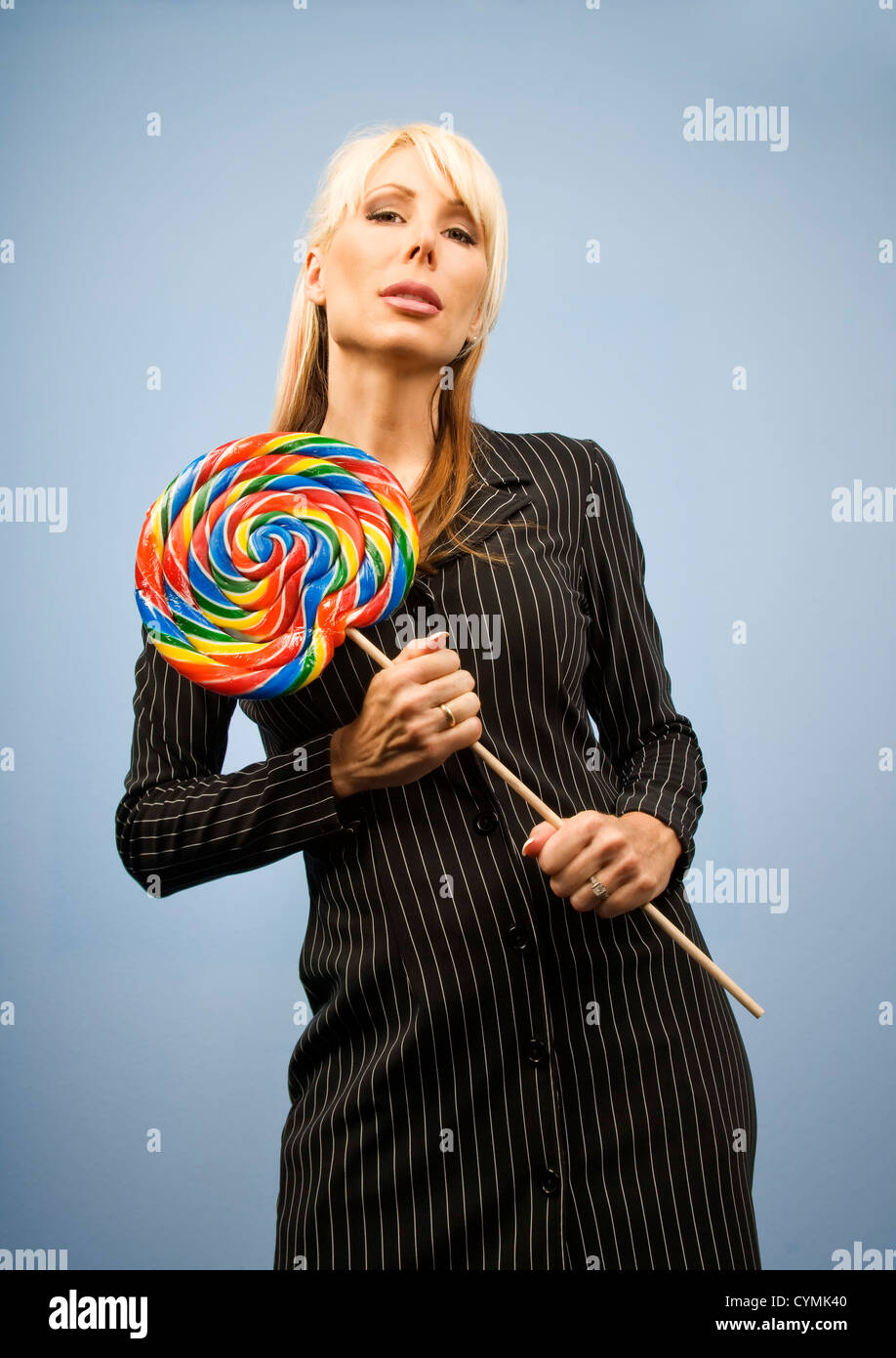 Woman holding a big colorful lollipop Stock Photo - Alamy