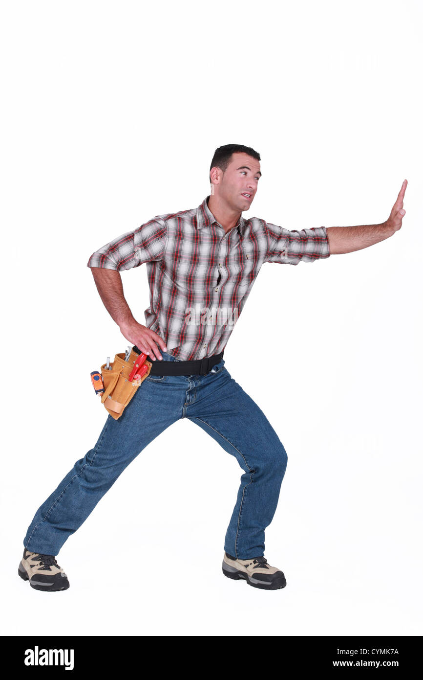 Construction worker miming Stock Photo - Alamy
