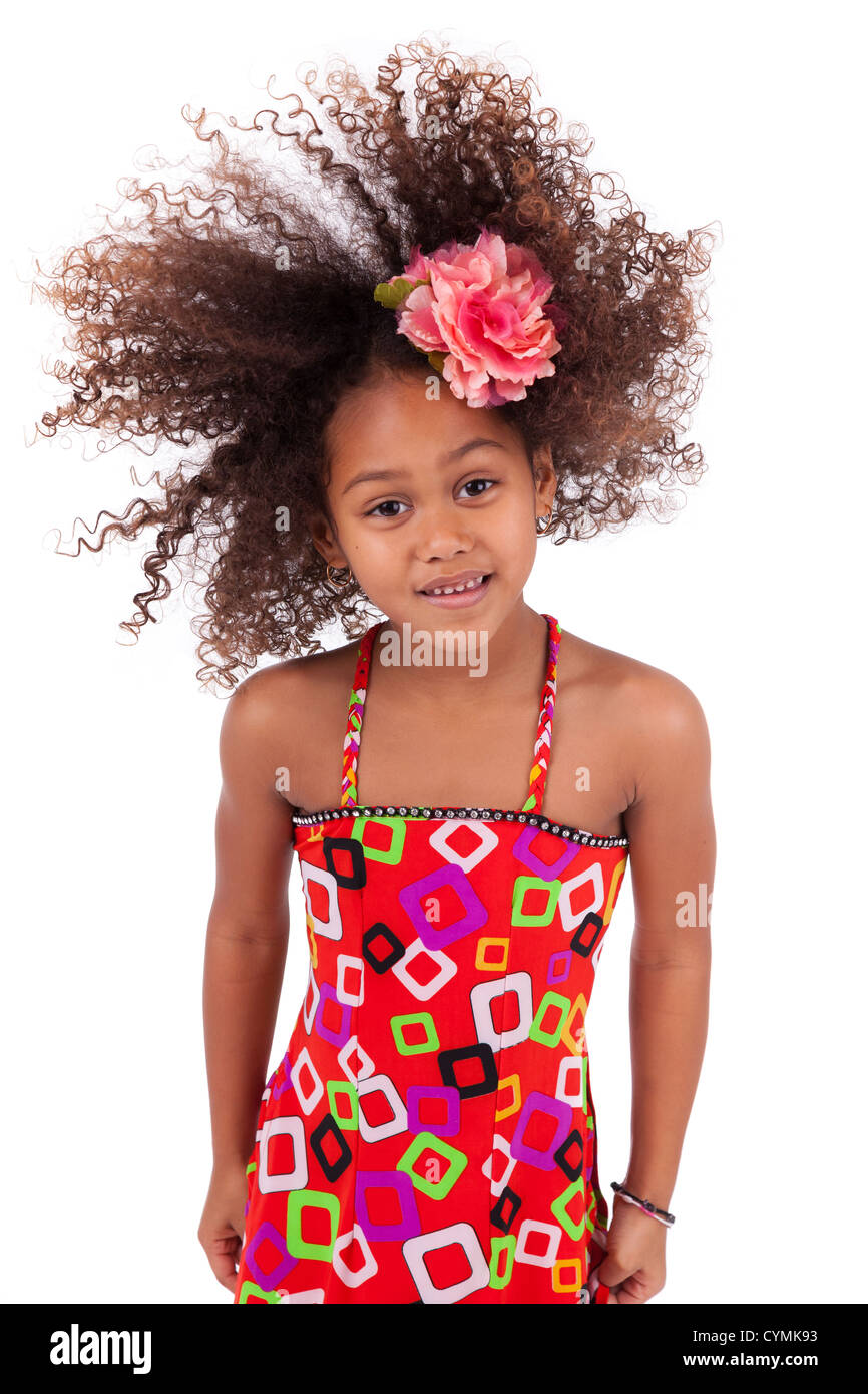 Portrait of a cute young African Asian girl playing with her hairs ...