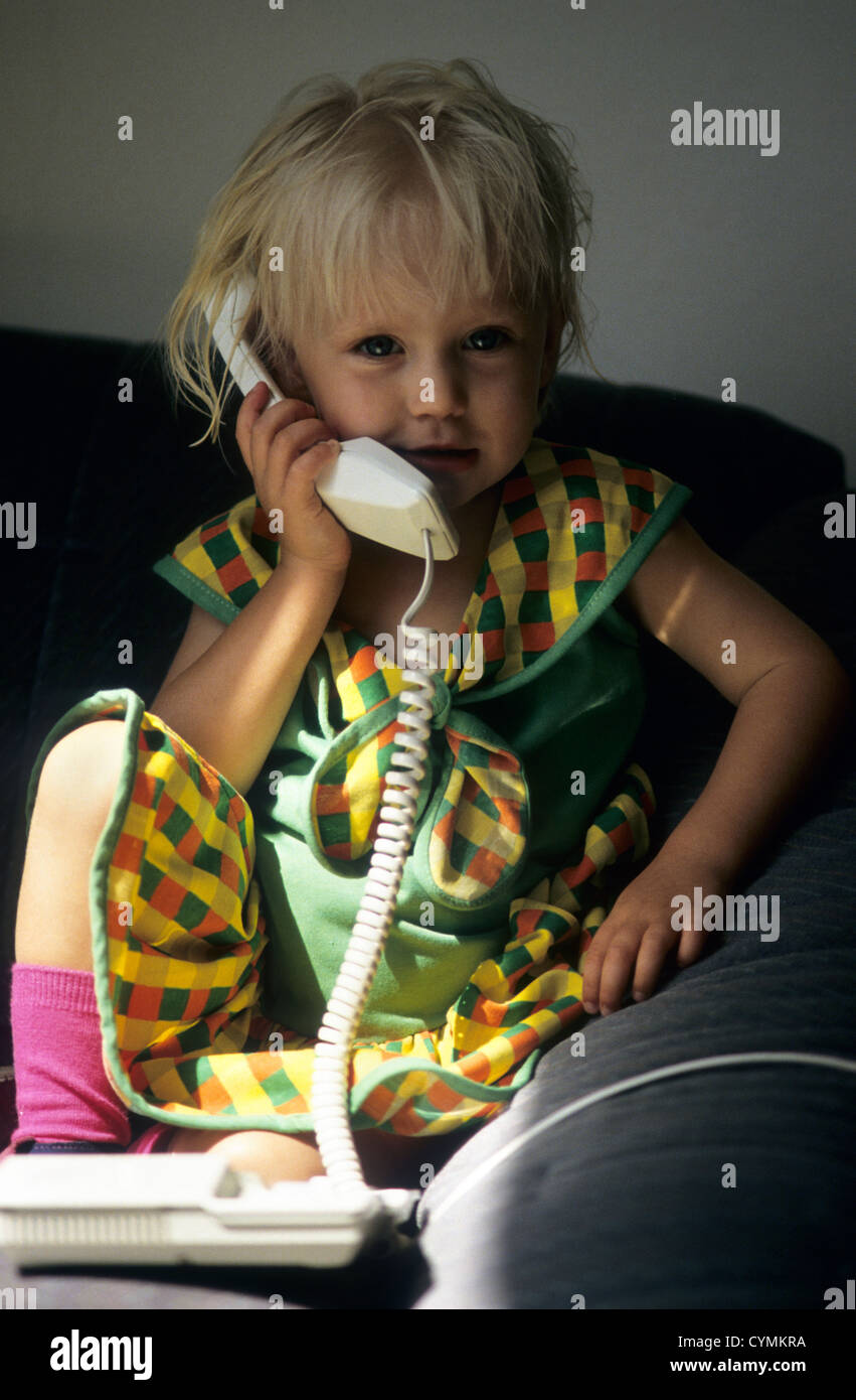 Children, three year old girl playing with house telephone Stock Photo ...