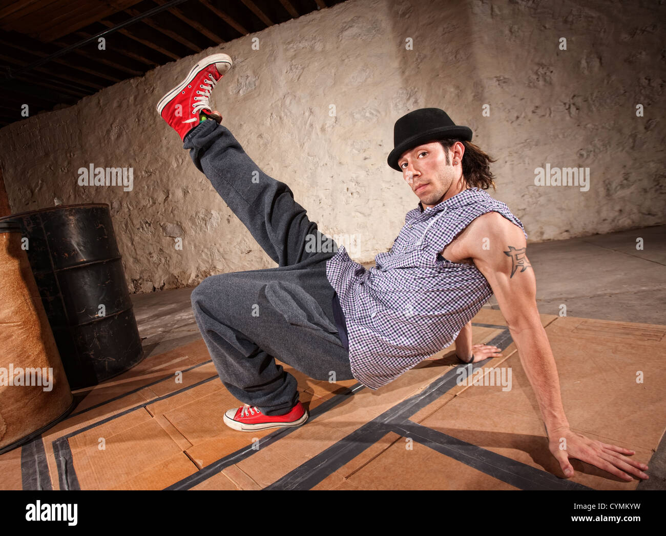 Handsome Latino male with leg up while break dancing Stock Photo - Alamy