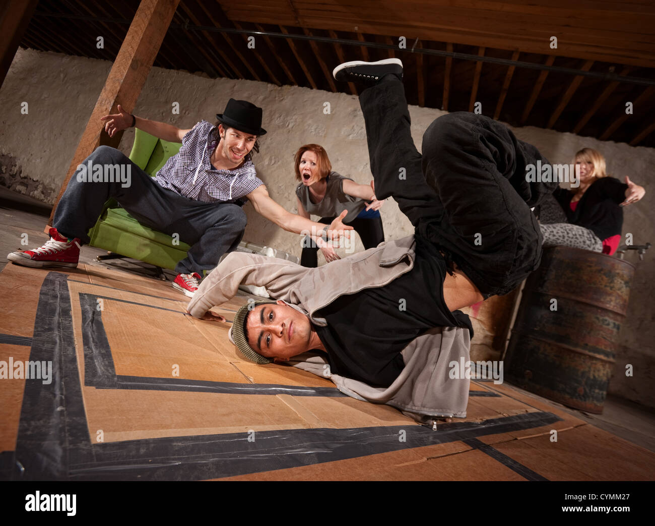 Handsome Hispanic male break dancer spinning on back Stock Photo - Alamy