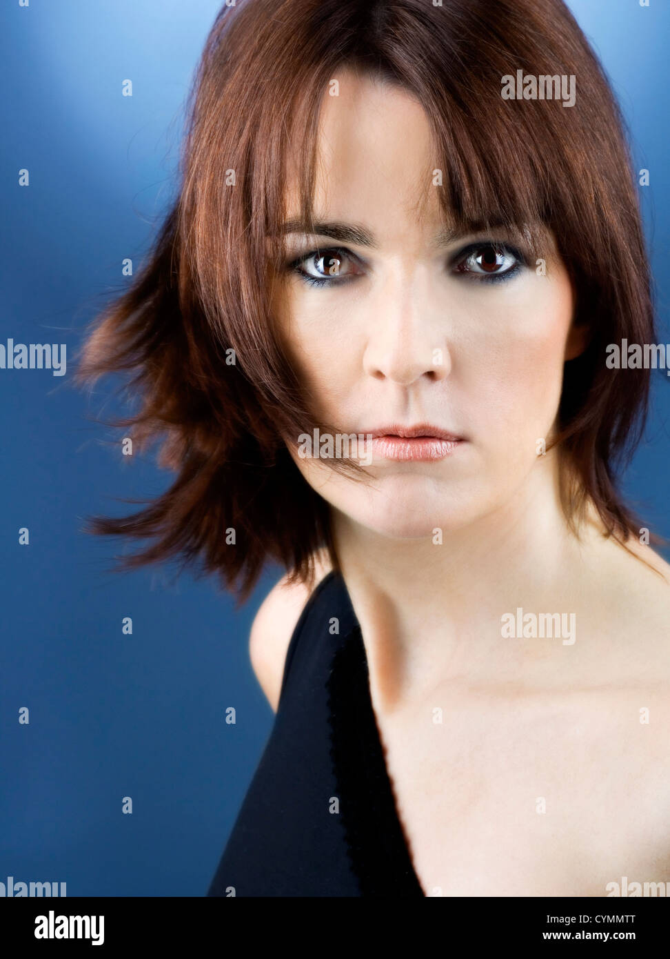 Beautiful woman over blue background Stock Photo - Alamy