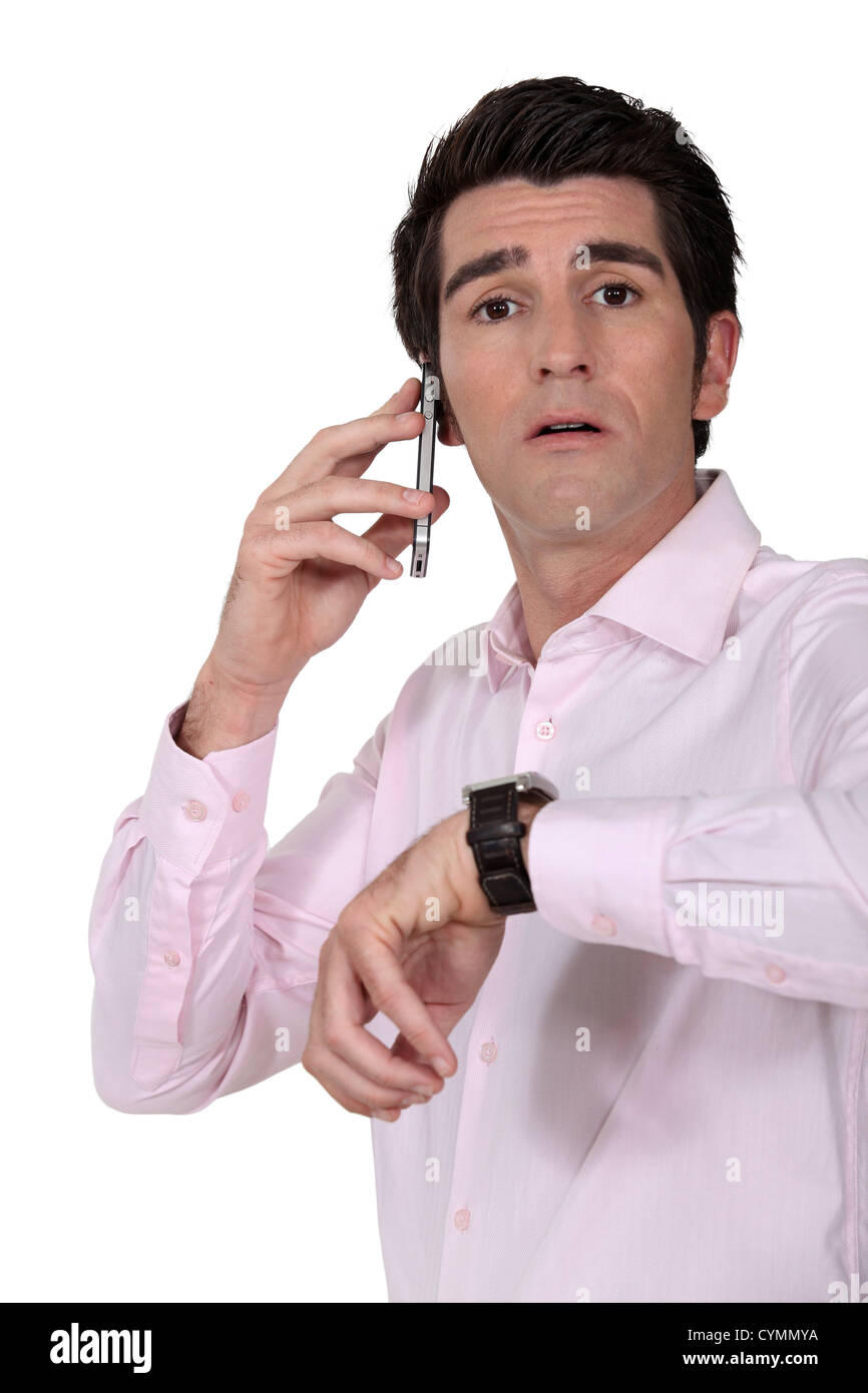 Businessman looking at the time Stock Photo - Alamy