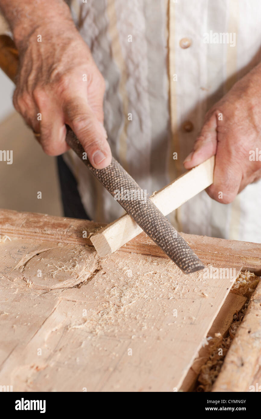 Carpenter working with a traditional rasp tool Stock Photo - Alamy
