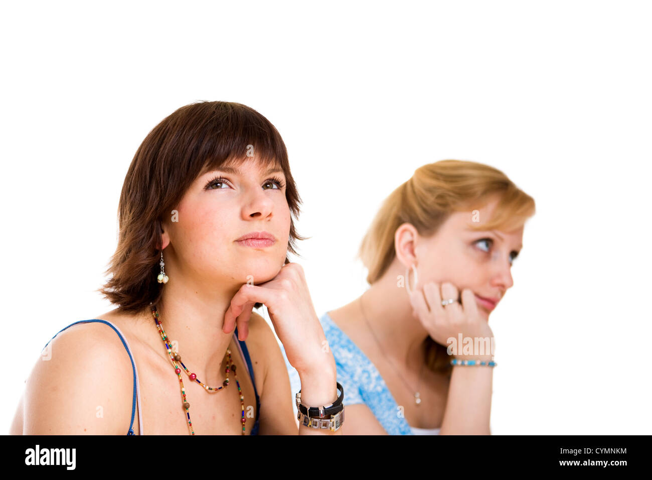 Two young woman thinking Stock Photo - Alamy