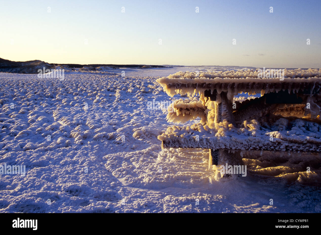 A picnic table covered in ice on the shore of Prince Edward Island ...