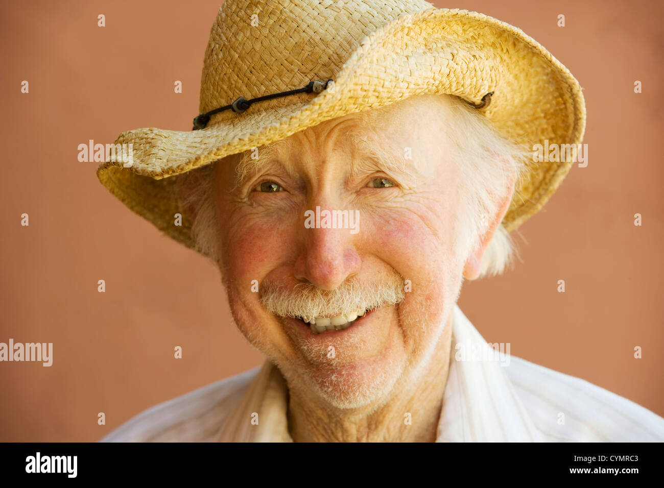 Senior Citizen Man Smiling in a Straw Cowboy Hat Stock Photo - Alamy