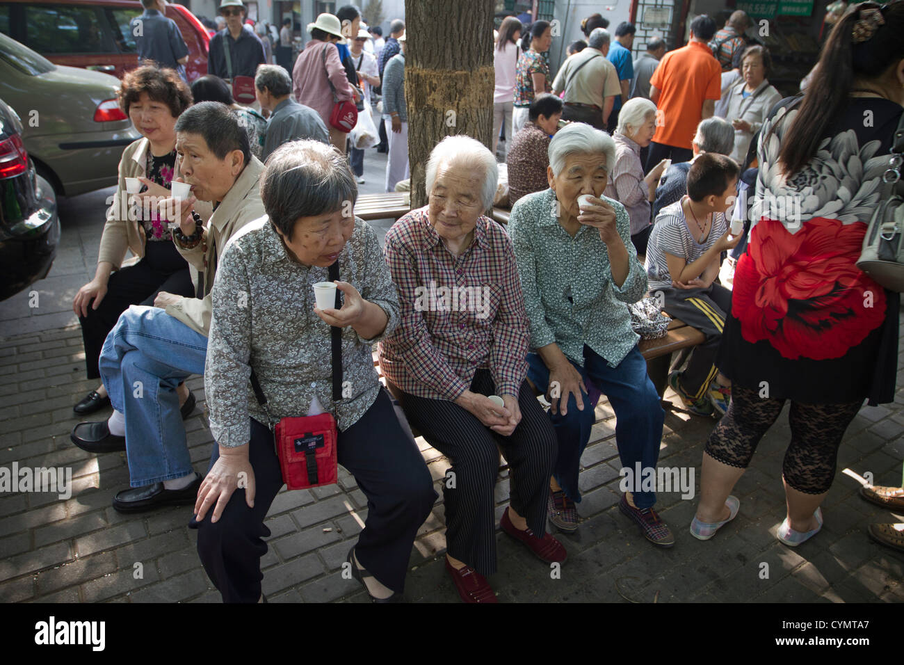 Three women relaxing drinking tea after taking part in morning ...