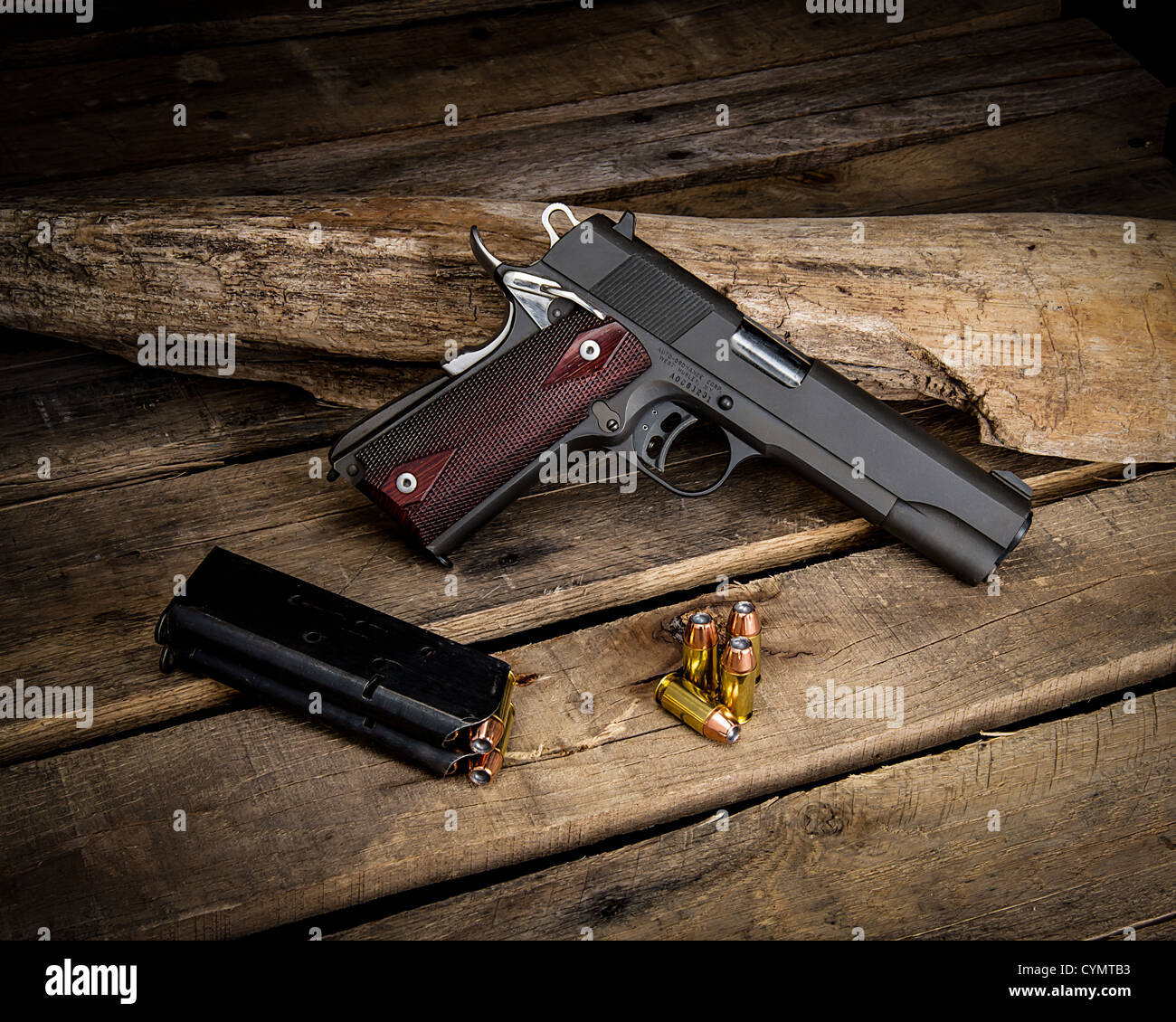 M1911 Pistol against a wooden background and displayed with a magazine ...