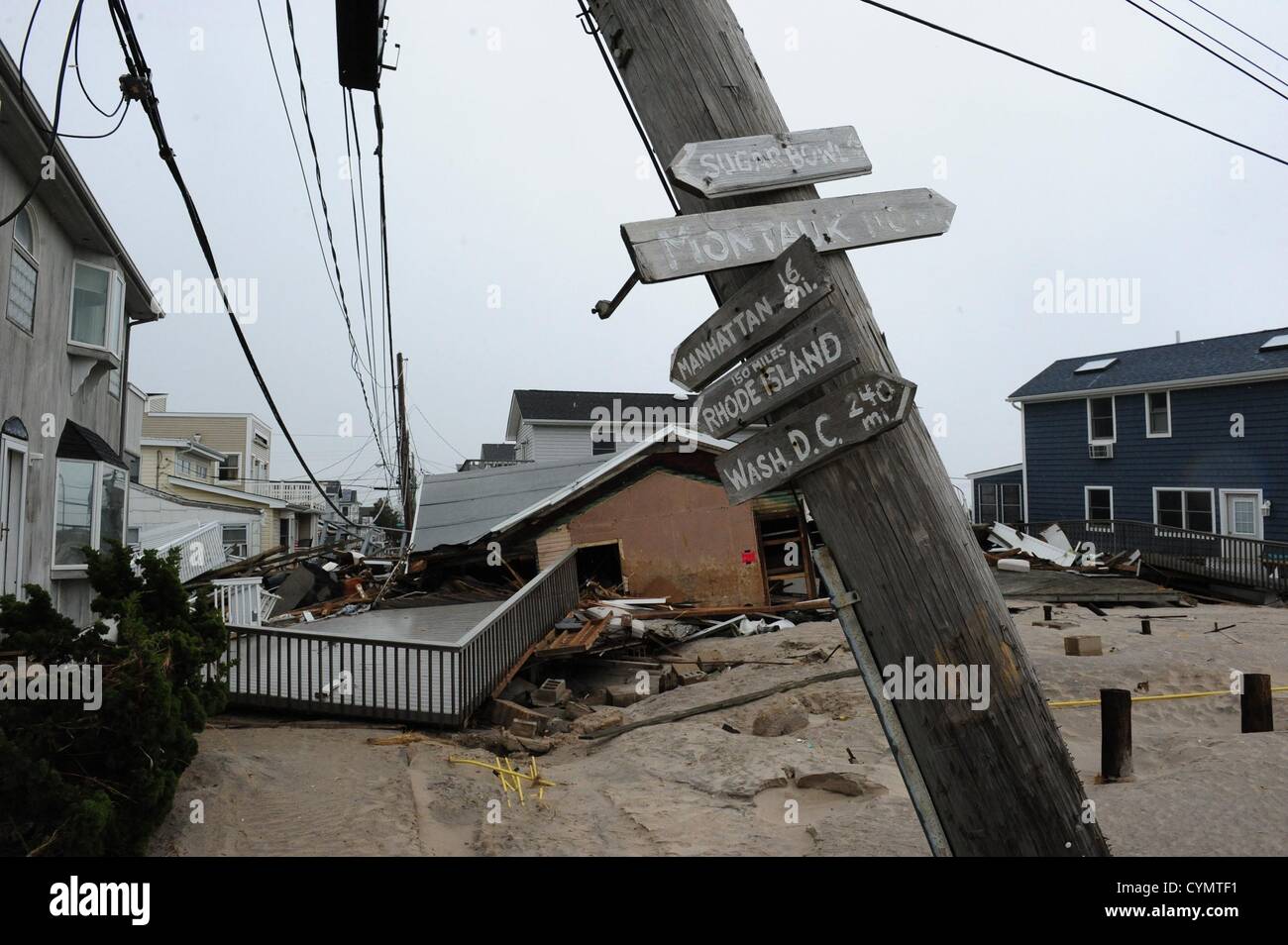 Nov. 7, 2012 - Queens, New York, U.S. - Signs on a leaning telephone ...