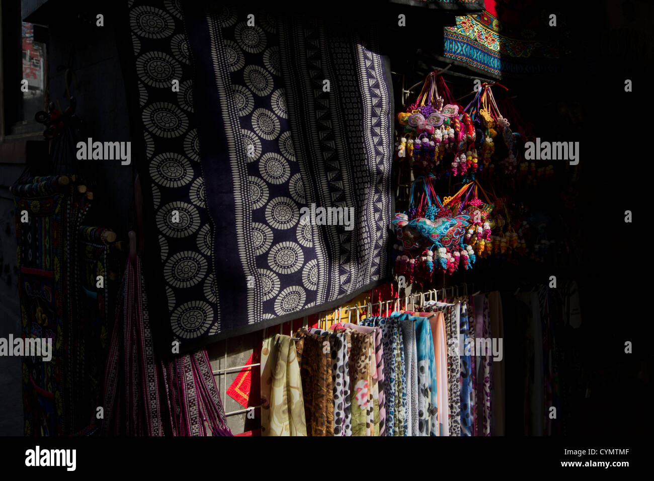 Fabrics and patterned cloth on display at a shop in a street in ...