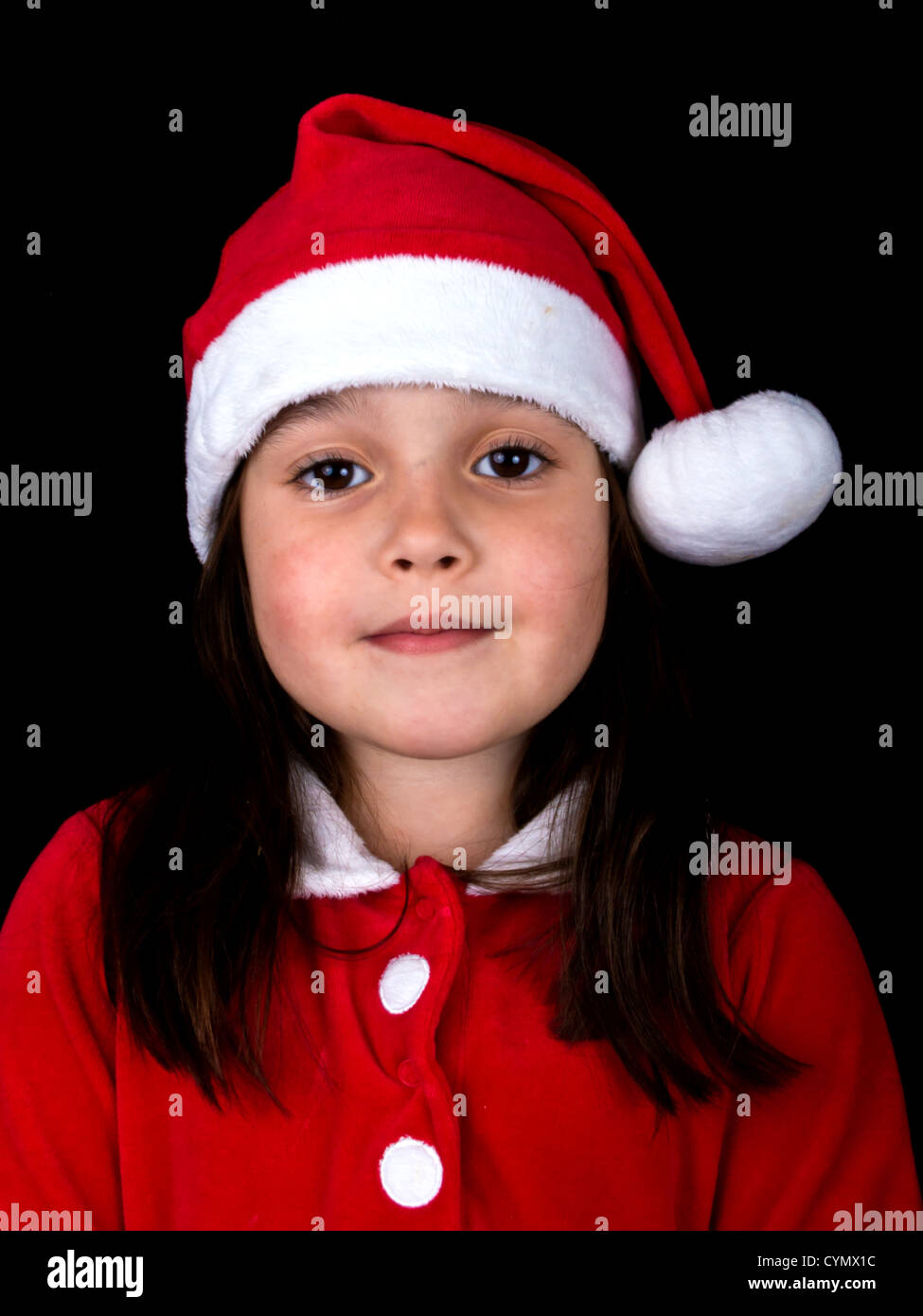 A young girl in a santa hat and costume Stock Photo - Alamy