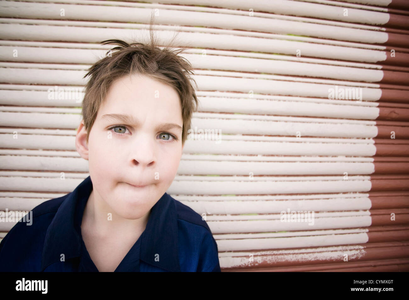 Young Boy with Looking Curious and Pursing His Lips Stock Photo - Alamy