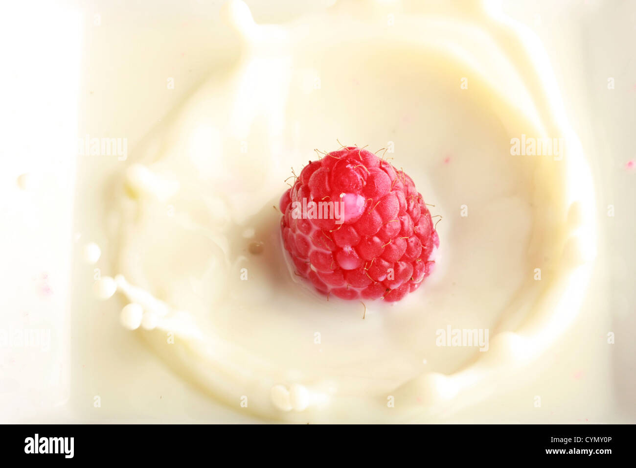 Red raspberry splashing in milk Stock Photo - Alamy