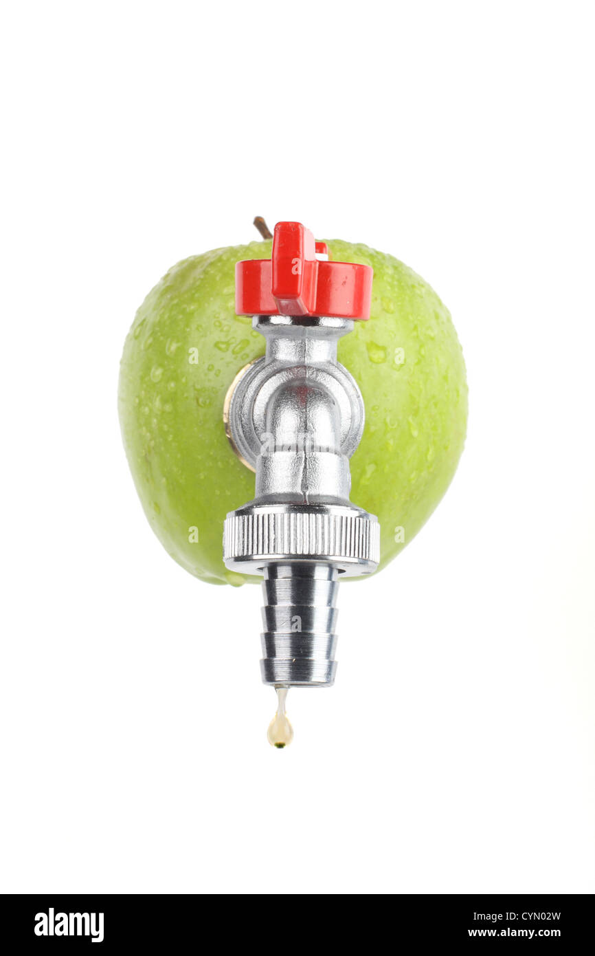 green apple with faucet, drop of apple juice dripping from it, isolated ...