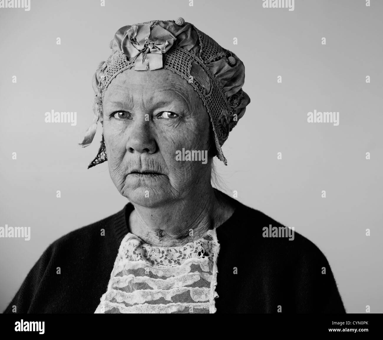 Dour senior woman in the studio wearing a vintage hat and lace Stock ...