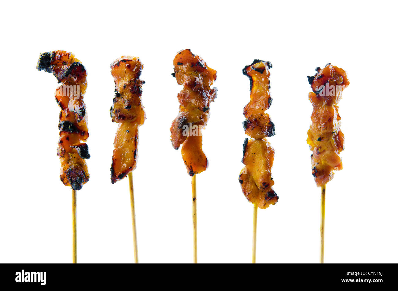 Five satay chicken sticks over white background Stock Photo - Alamy