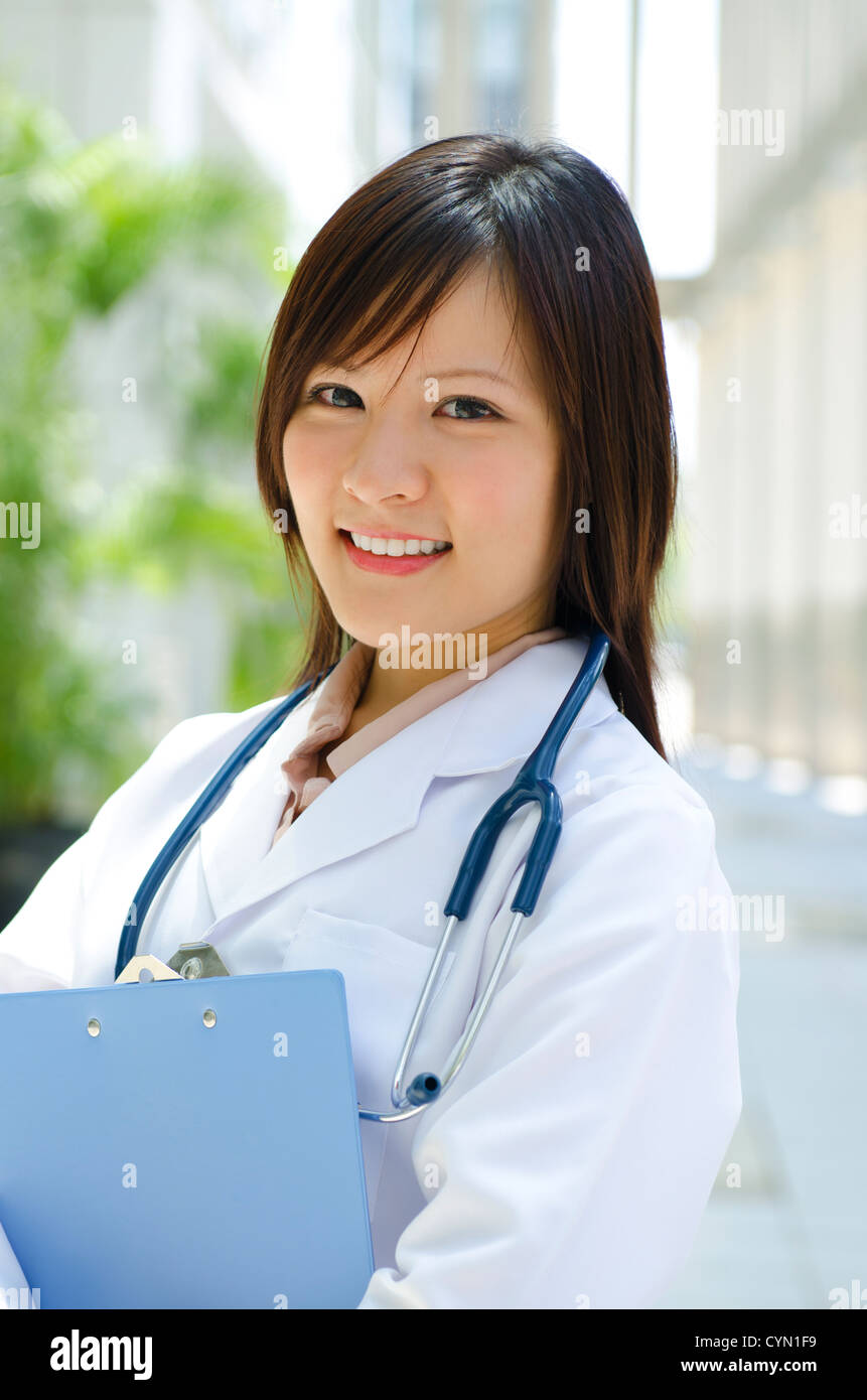A young Asian Chinese medical student standing in front modern building ...
