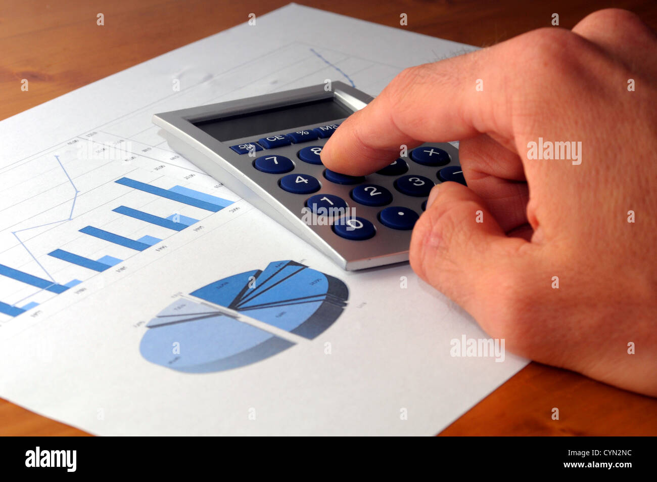 business chart graph or diagram and hand on desktop Stock Photo - Alamy