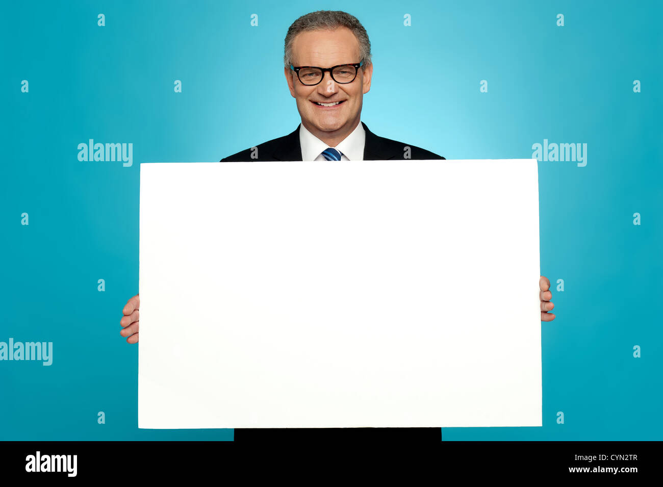 Business representative holding blank ad board and smiling at camera ...