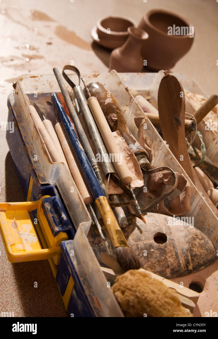 Tools for forming clay with pots in background Stock Photo - Alamy