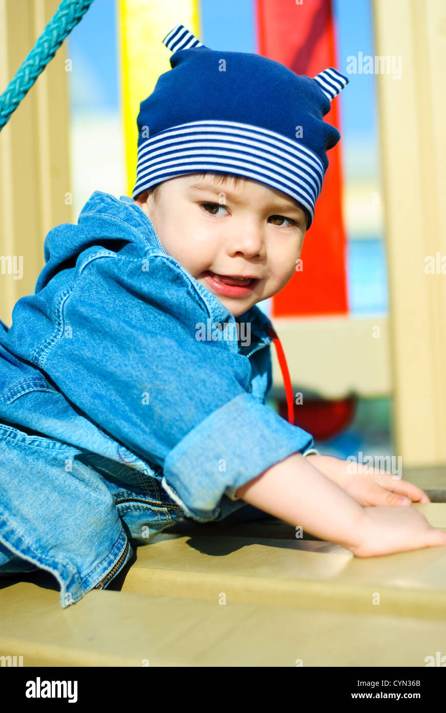 cute three year old boy playing outdoor at the Children's playground ...
