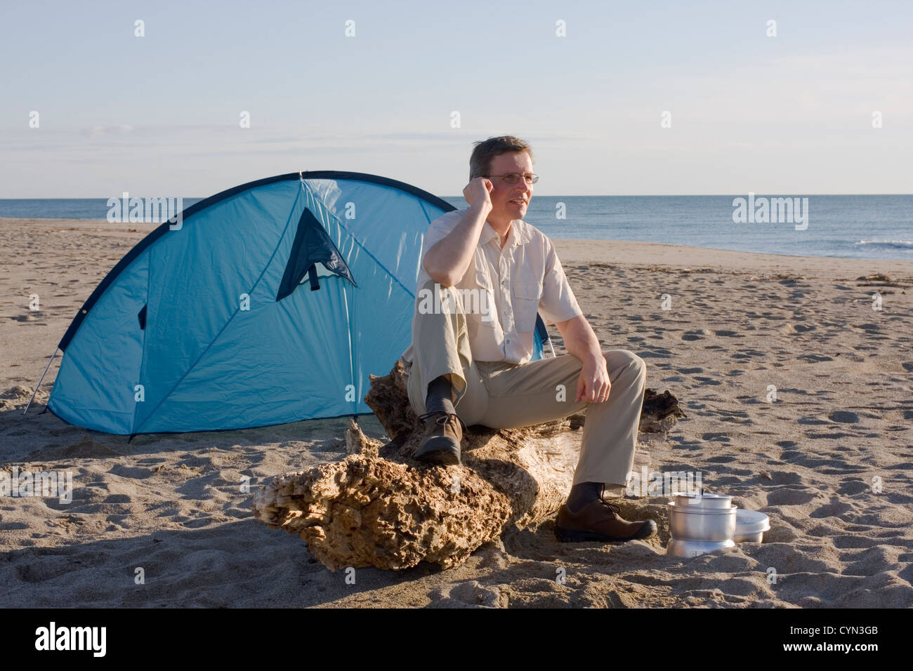 Man with tent on beach Stock Photo - Alamy