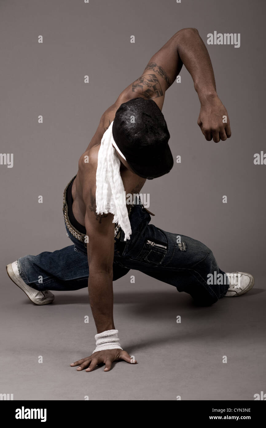 Modern man doing single handed steps on grey background Stock Photo - Alamy