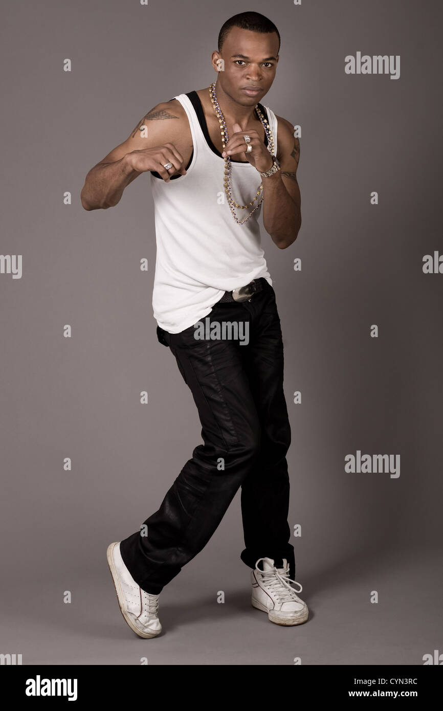 Cool african guy dancing on grey background Stock Photo - Alamy