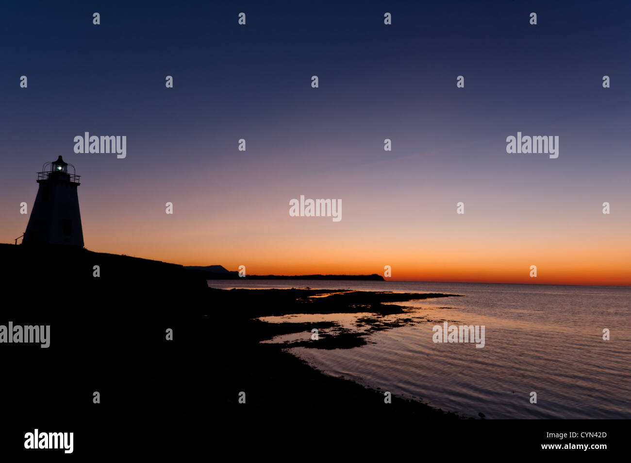 Lighthouse in the dark light of an early morning Stock Photo - Alamy
