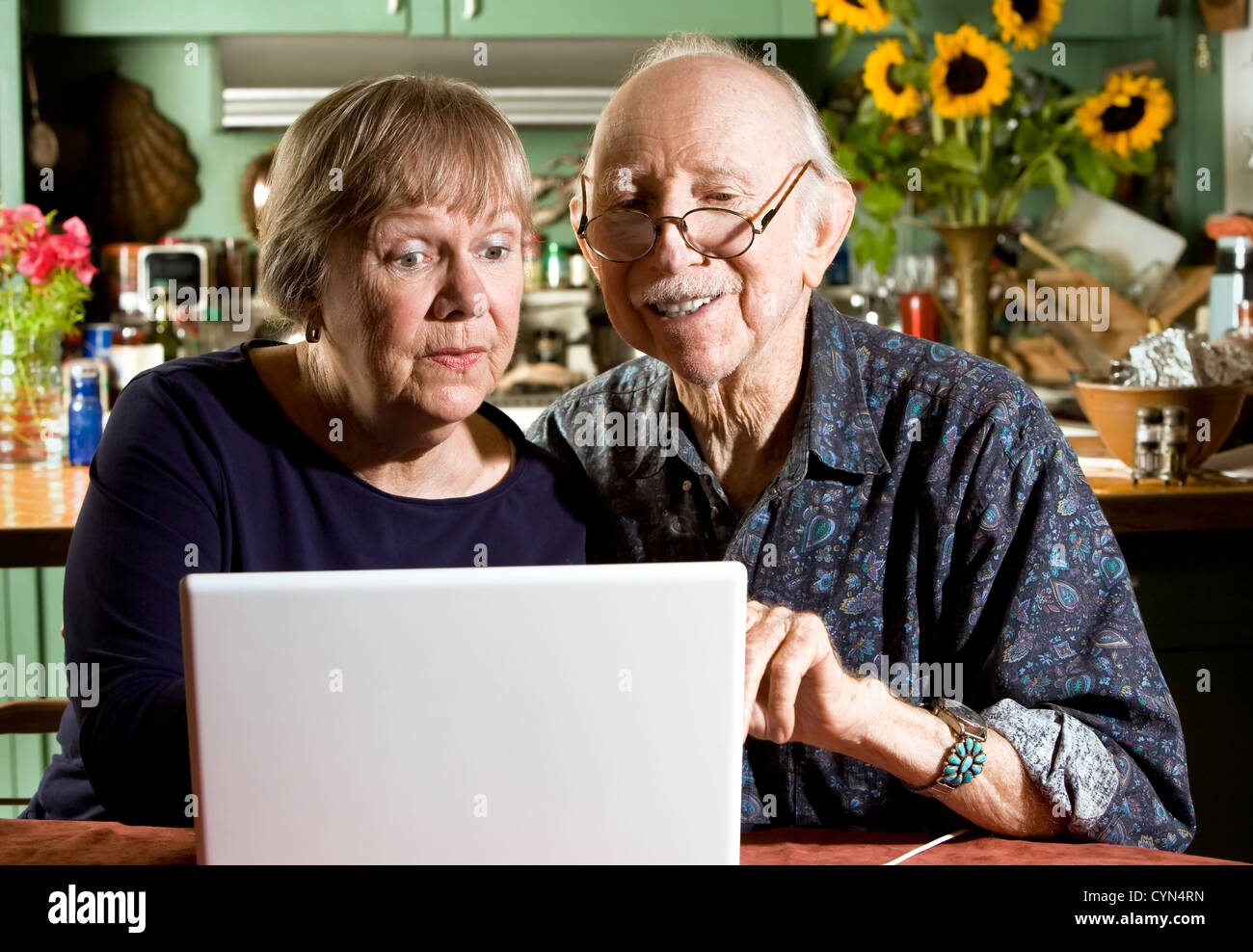 Senior Couple in their Dining Room with a Laptop Computer Stock Photo ...