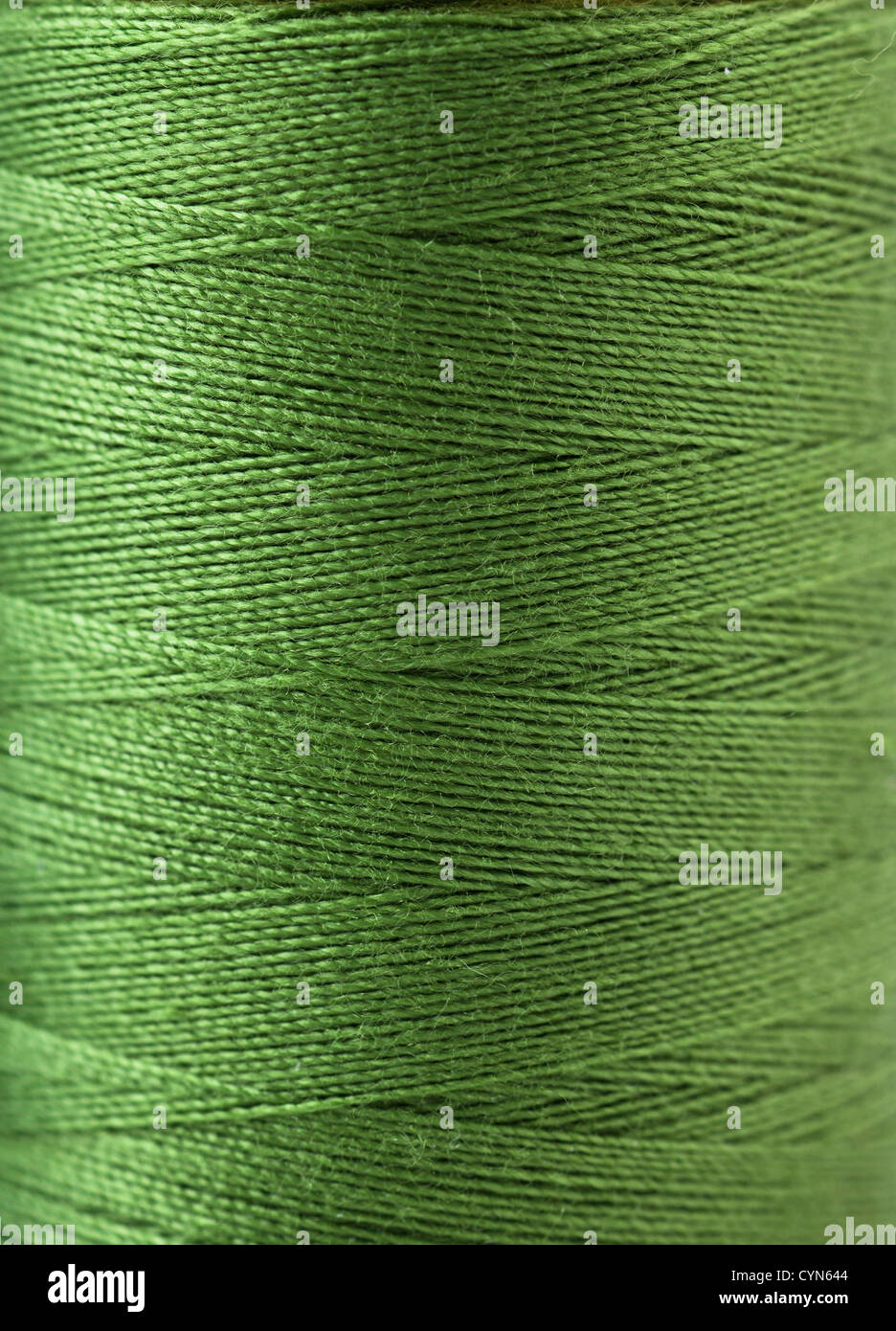 Macro view of green thread wound on a spool Stock Photo - Alamy
