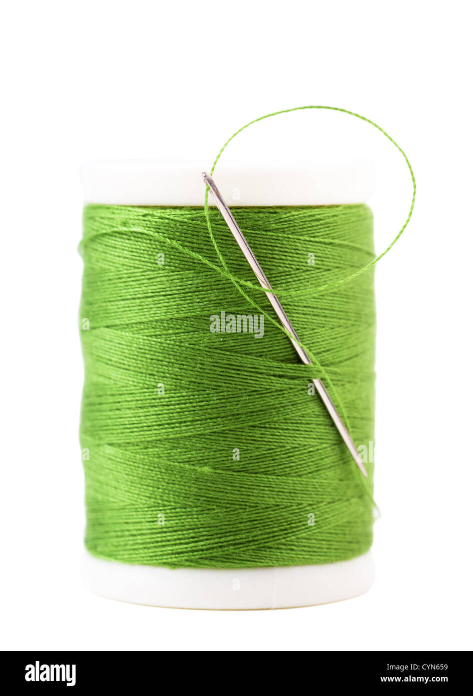 Single spool with green thread and needle Stock Photo - Alamy