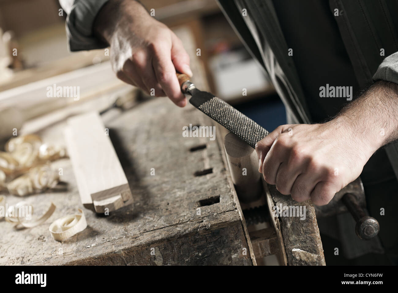 Carpenter working on a piece of wood with a file Stock Photo - Alamy