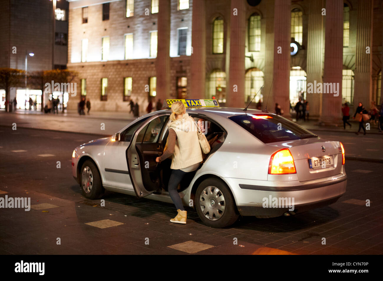 Woman getting in taxi night hi-res stock photography and images - Alamy