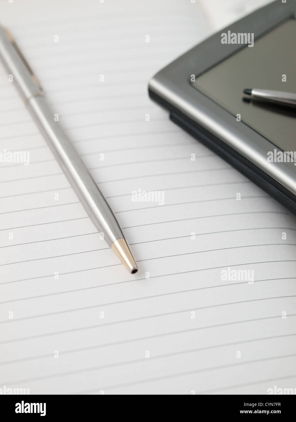 A pen and a pda on a notebook ready to take notes Stock Photo - Alamy
